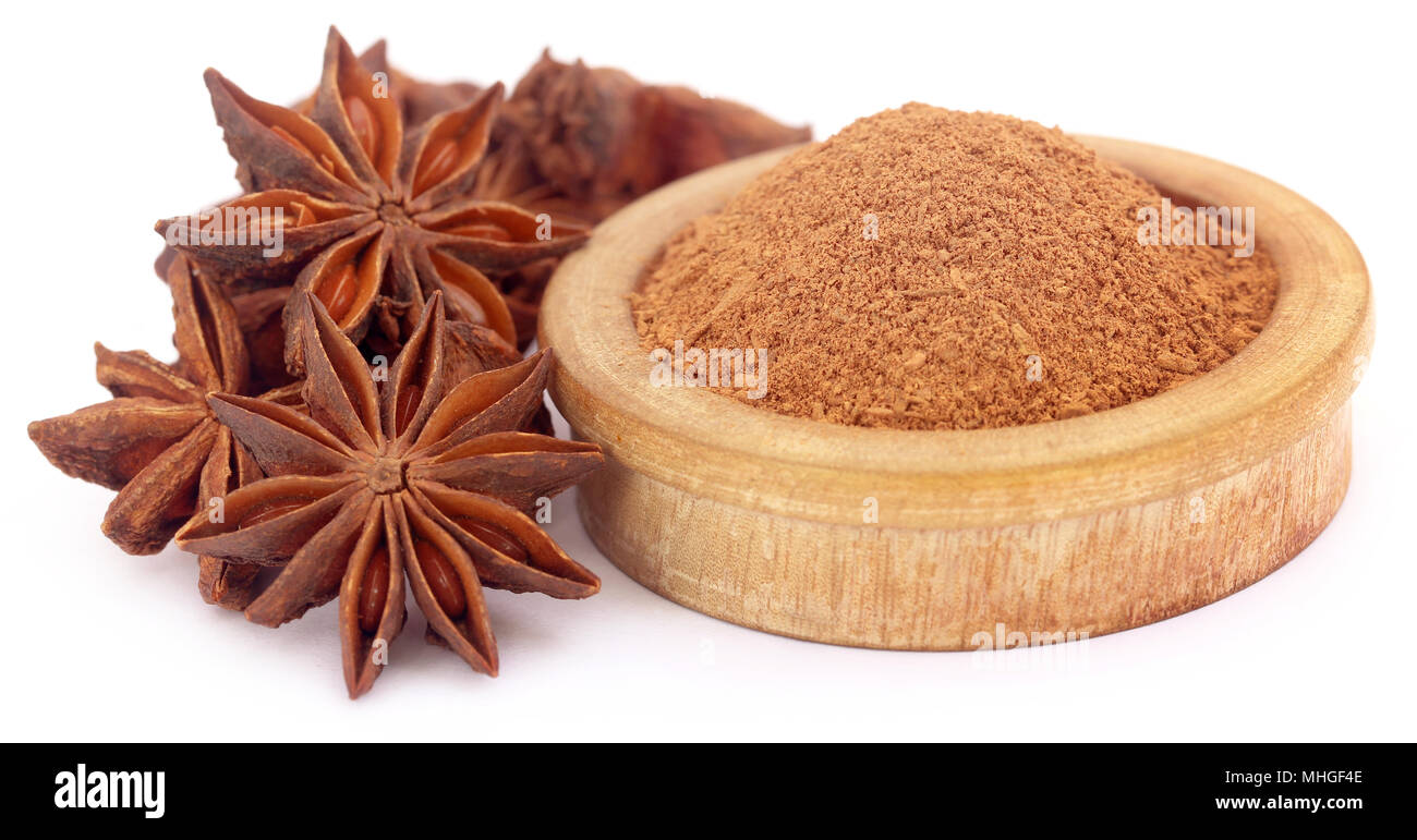 Aromatic star anise with powdered spice over white background Stock ...