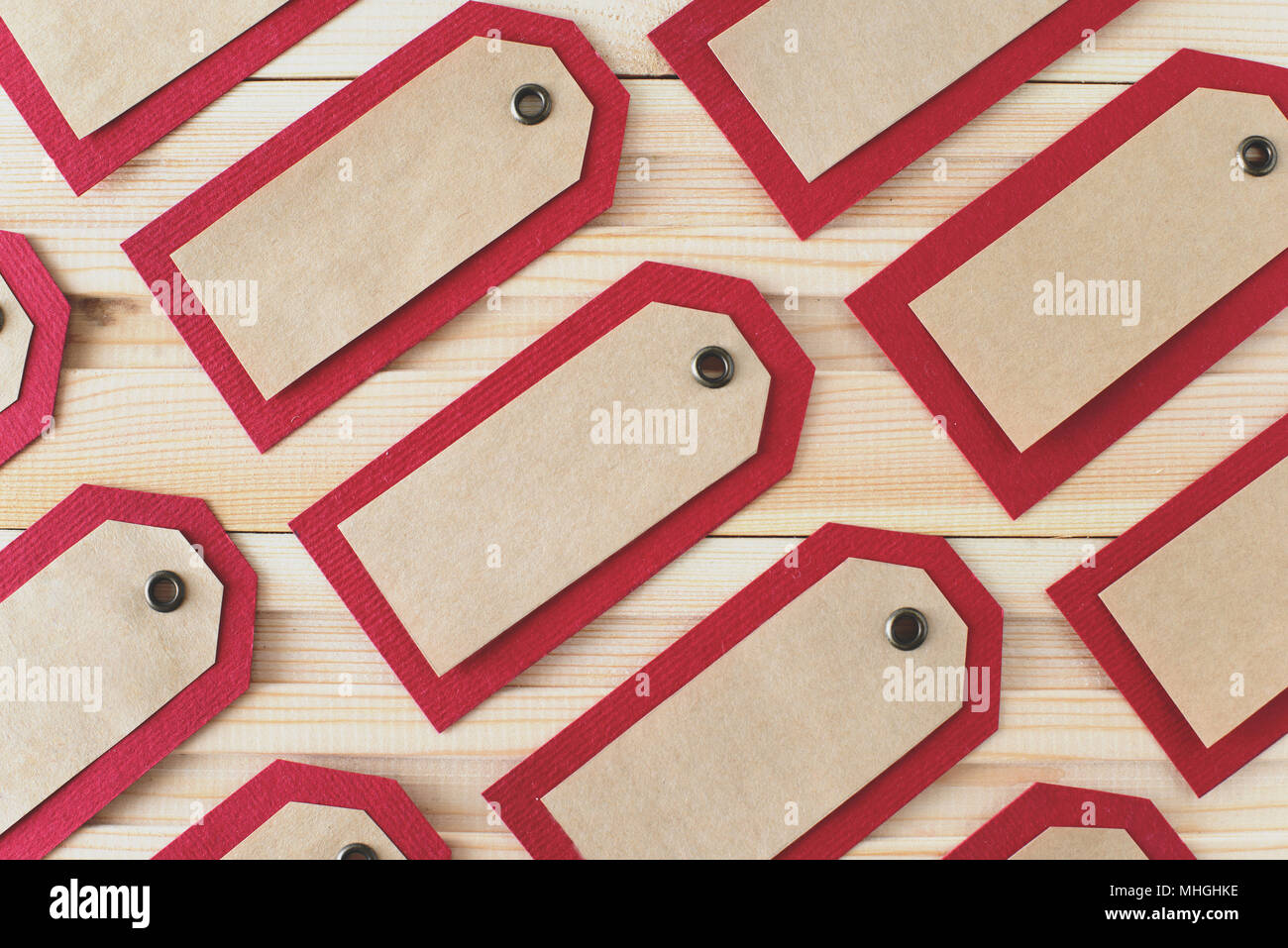 Recycled craft paper red tags in a row on vintage wooden table ...