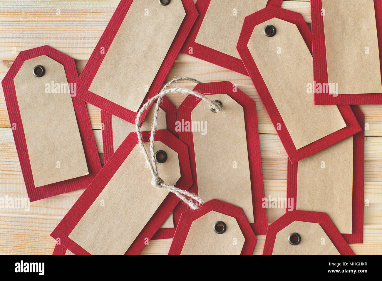 Recycled craft paper red tags and rope on vintage wooden table ...
