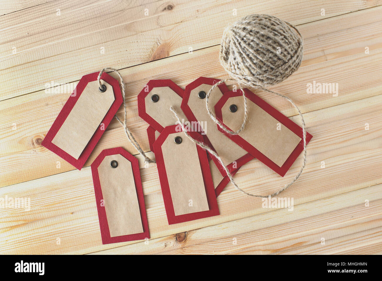 Recycled craft paper red tags and rope on vintage wooden table ...