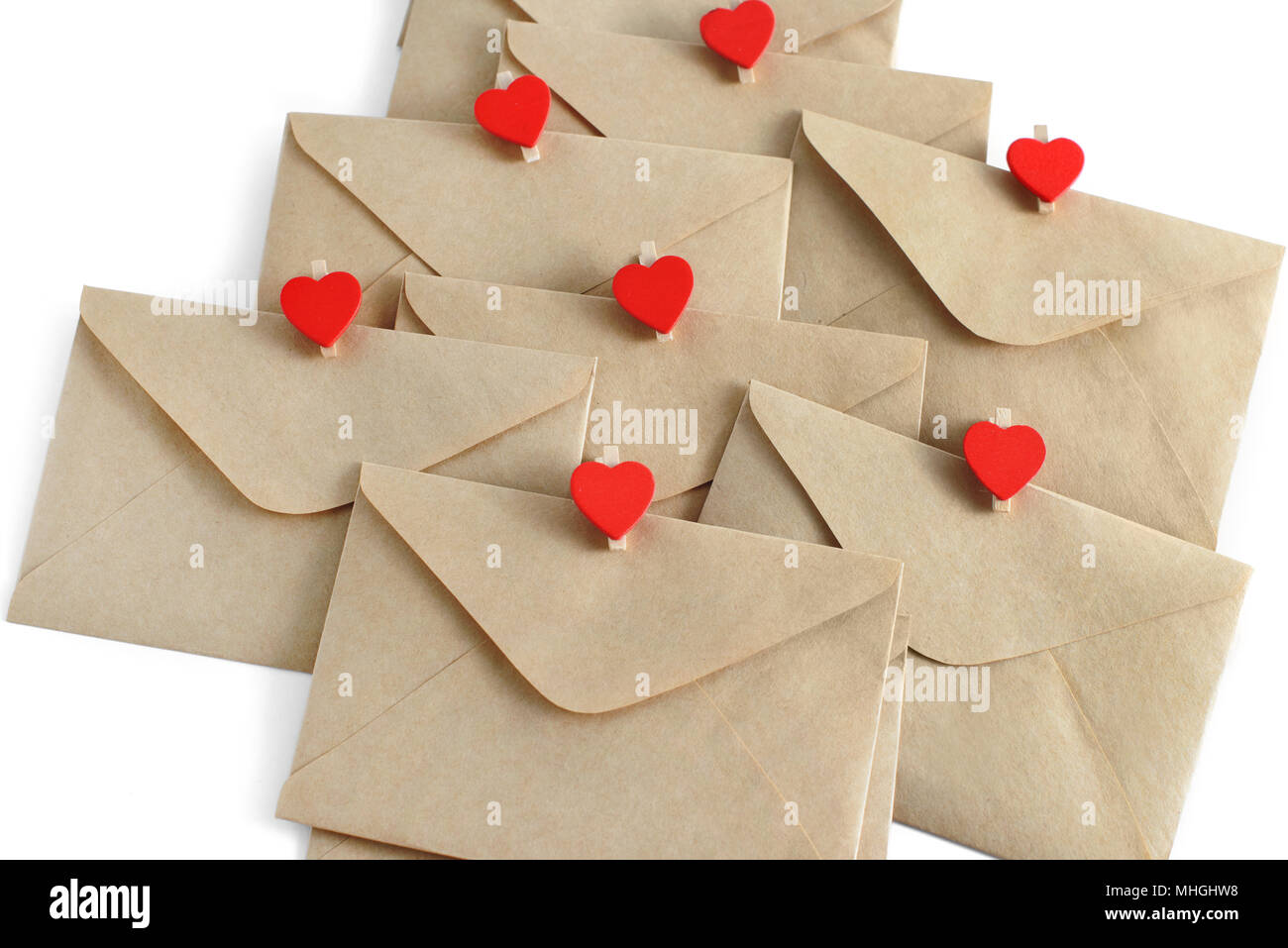 Envelopes from craft paper with red heart pins isolated on white ...