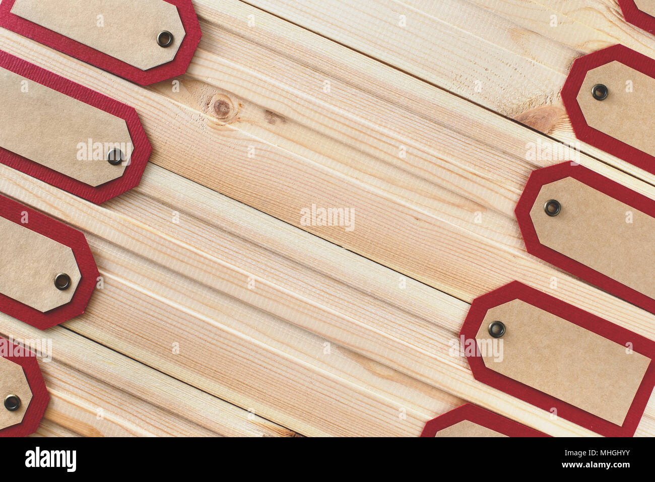 Recycled craft paper red tags in a row on vintage wooden table ...