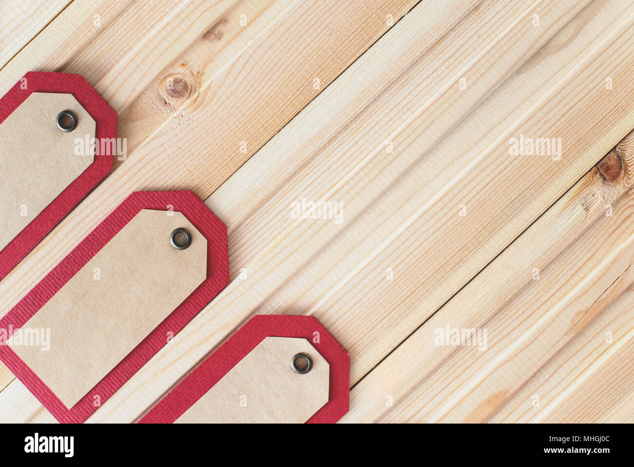 Recycled craft paper red tags in a row on vintage wooden table ...