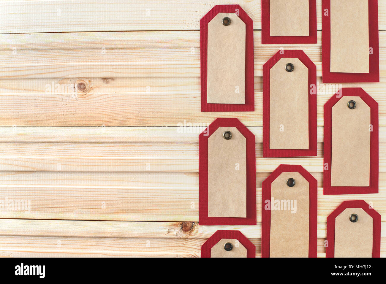 Recycled craft paper red tags in a row on vintage wooden table ...