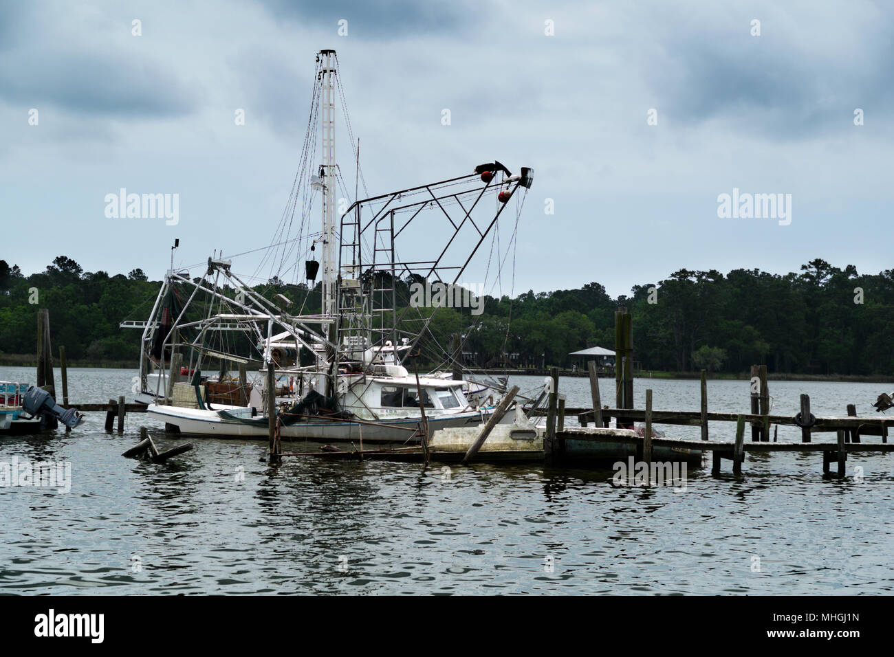 Abandoned storm damaged boats sit dockside on the Bon Secour River in ...