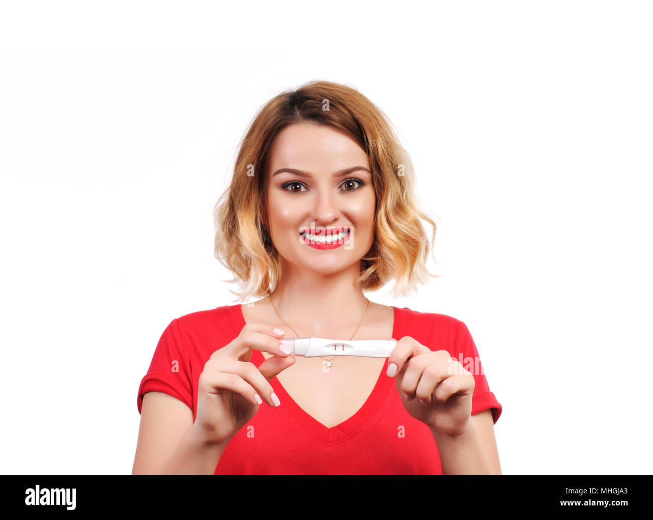 Happy woman showing a positive pregnancy test Stock Photo - Alamy