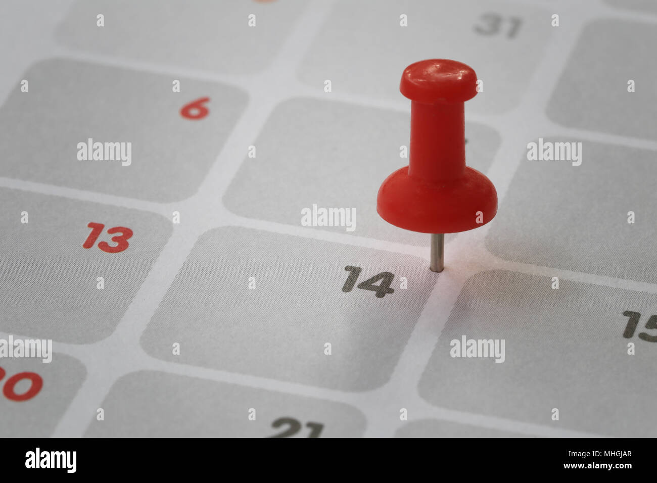 Red pin put on the calendar background in number fourteen concept of ...