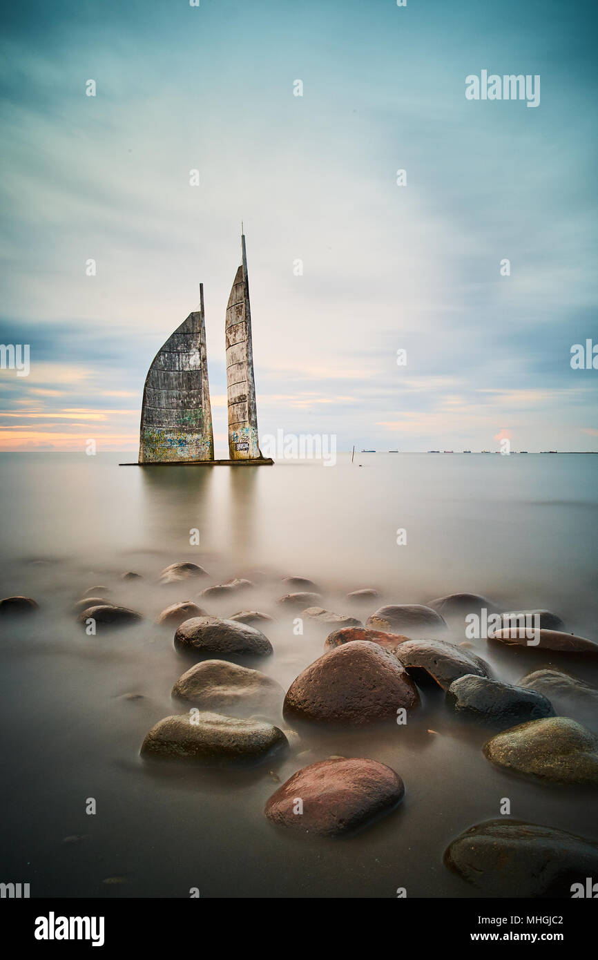 Rocky Beach with a concrete structure Stock Photo - Alamy