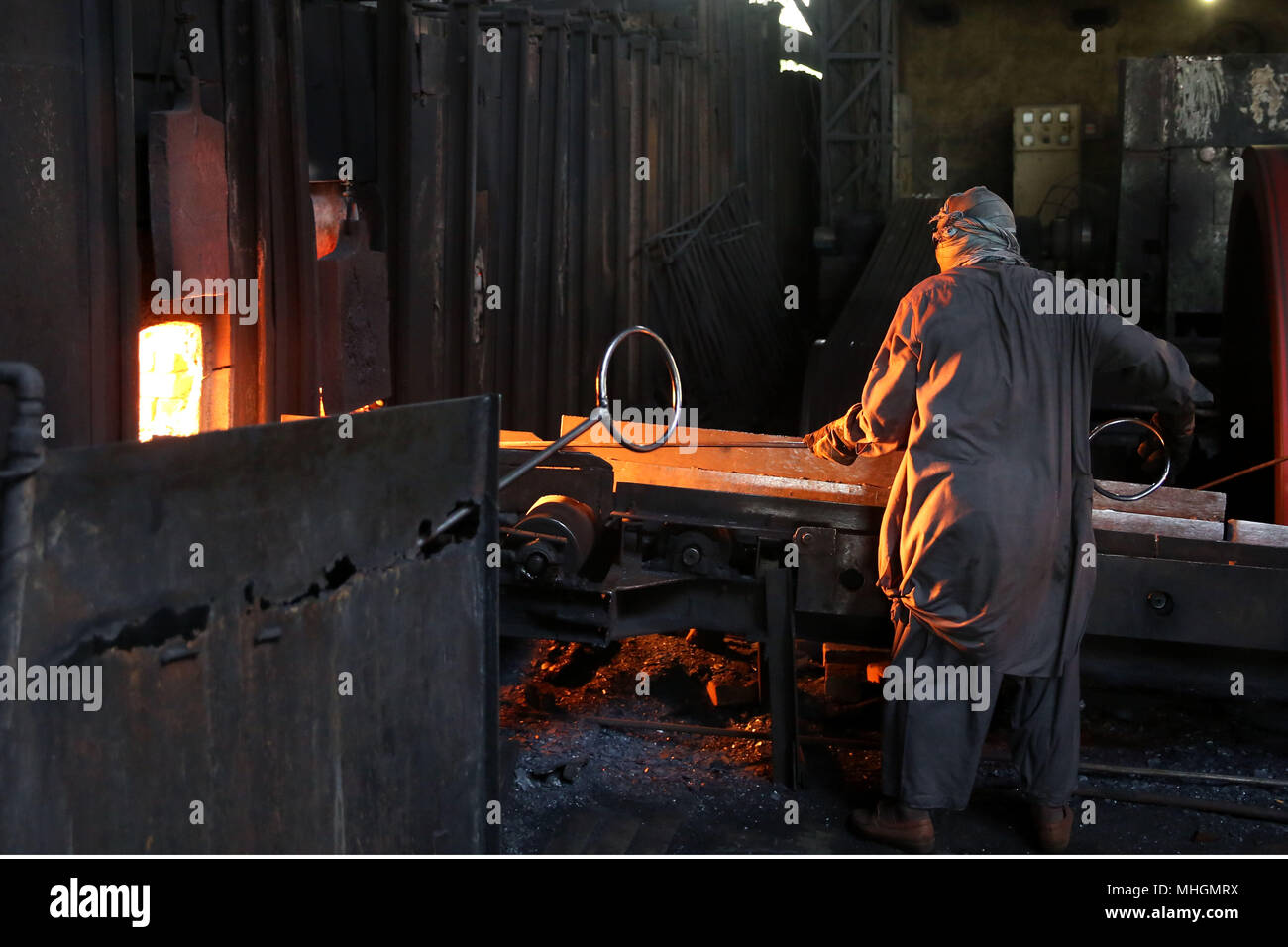 Islamabad. 1st May, 2018. A laborer works at an iron factory on Labor ...