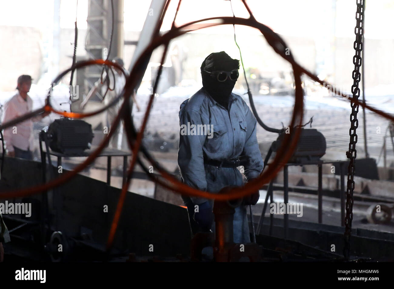 Islamabad. 1st May, 2018. A laborer works at an iron factory on Labor ...