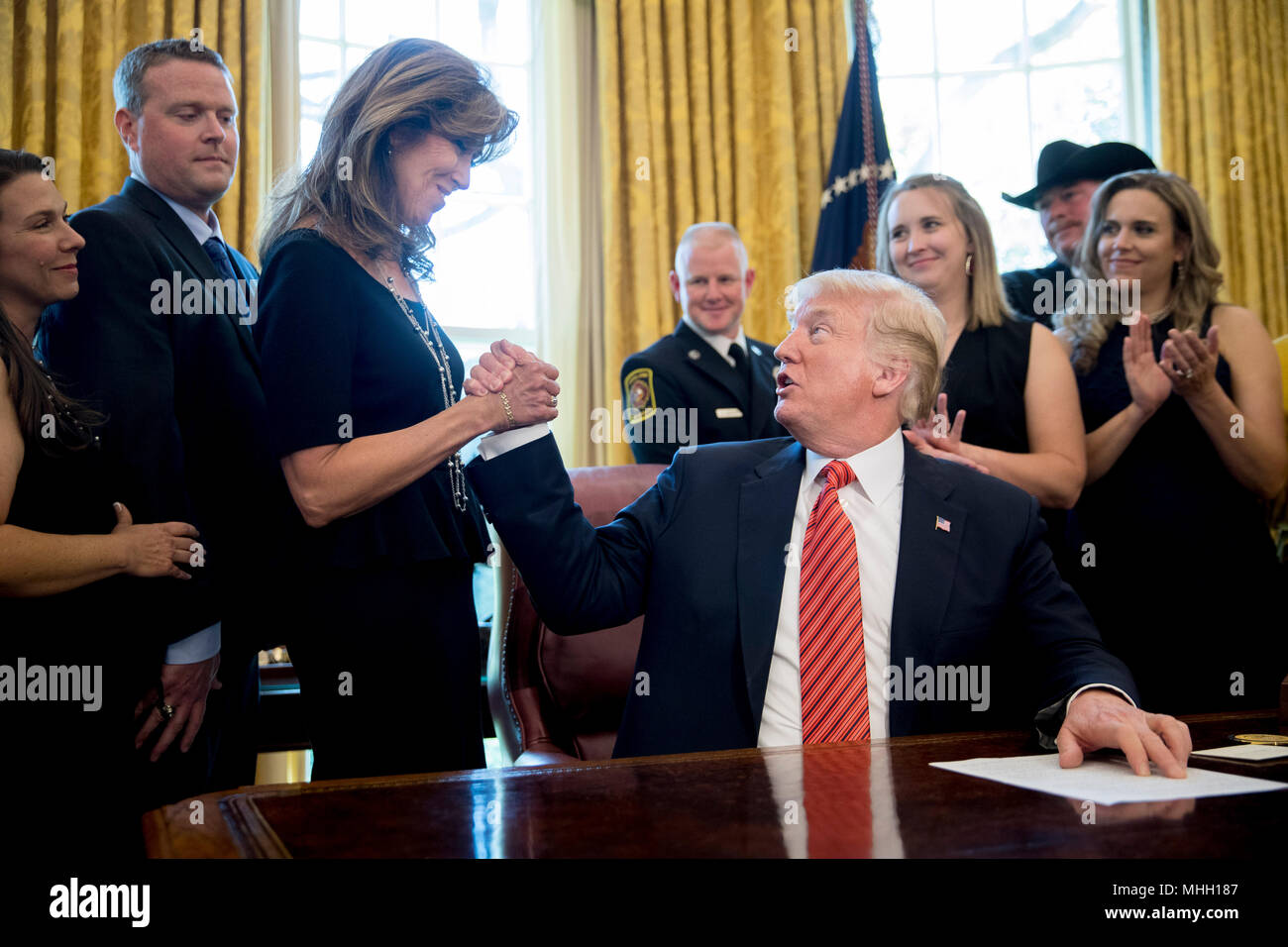 United States President Donald Trump, right, shakes hands with Tammie ...