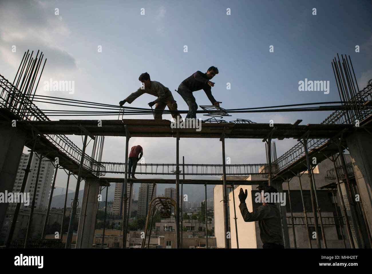 Tehran, Iran. 1st May, 2018. Workers are seen at a construction site on ...