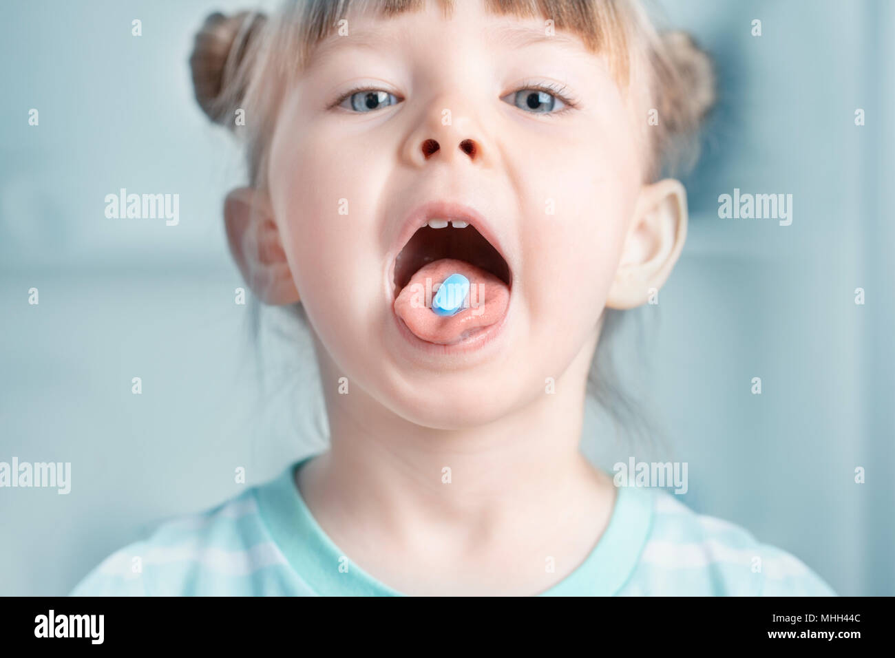 Close up of child puts the pill in his mouth Child is sick with tablet ...