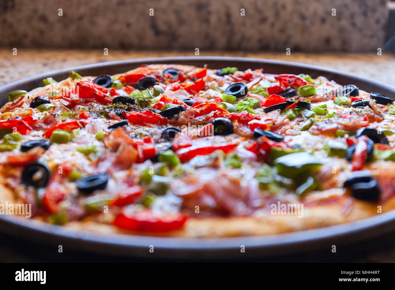 Freshly baked hot pizza in a frying pan. American style. Thick crust ...