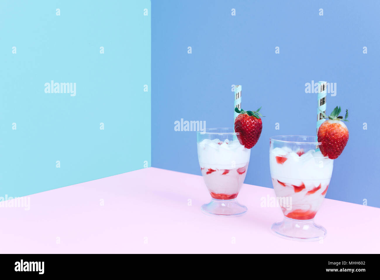 Milkshake with straw and strawberry Stock Photo - Alamy