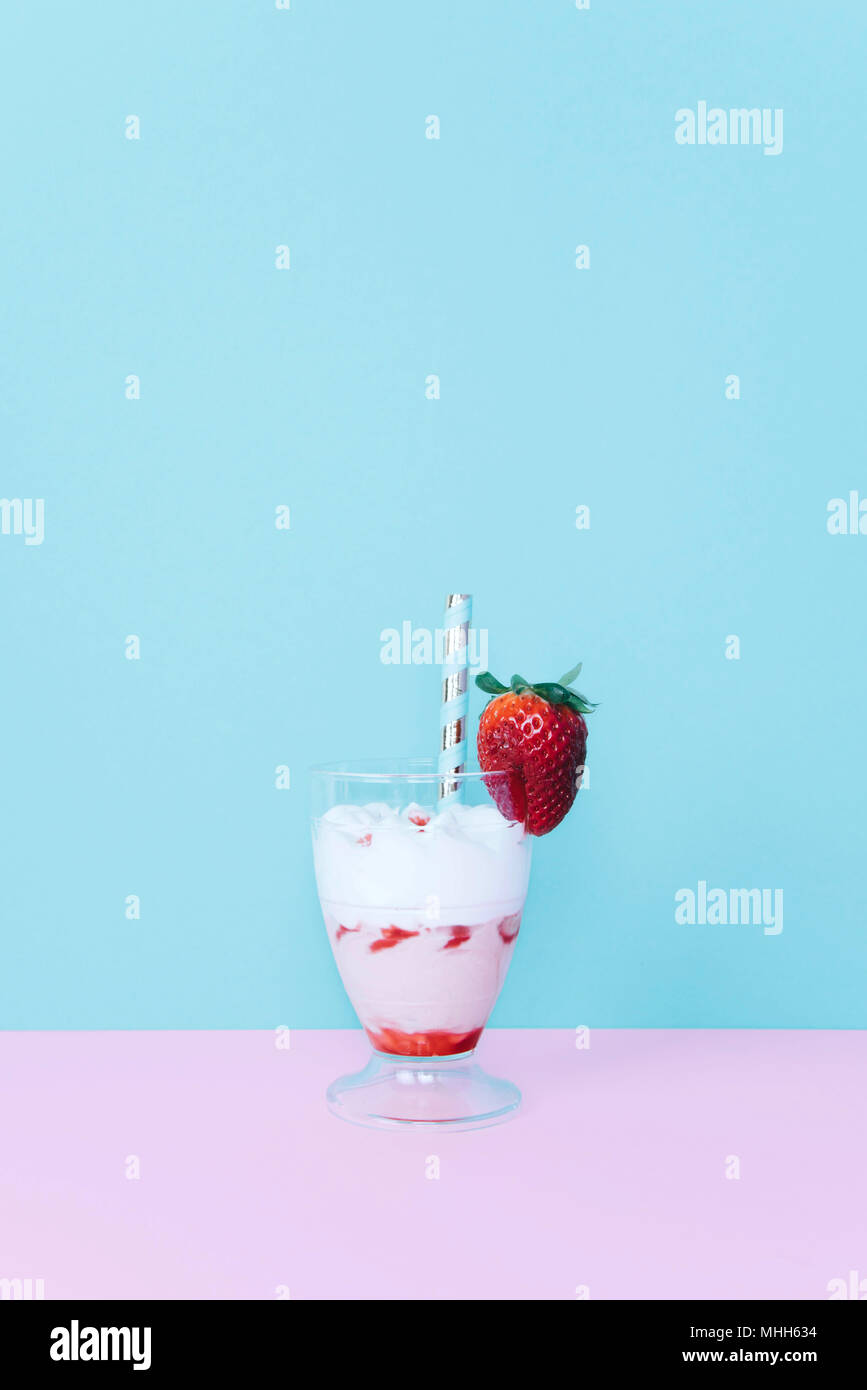 Milkshake with straw and strawberry Stock Photo - Alamy