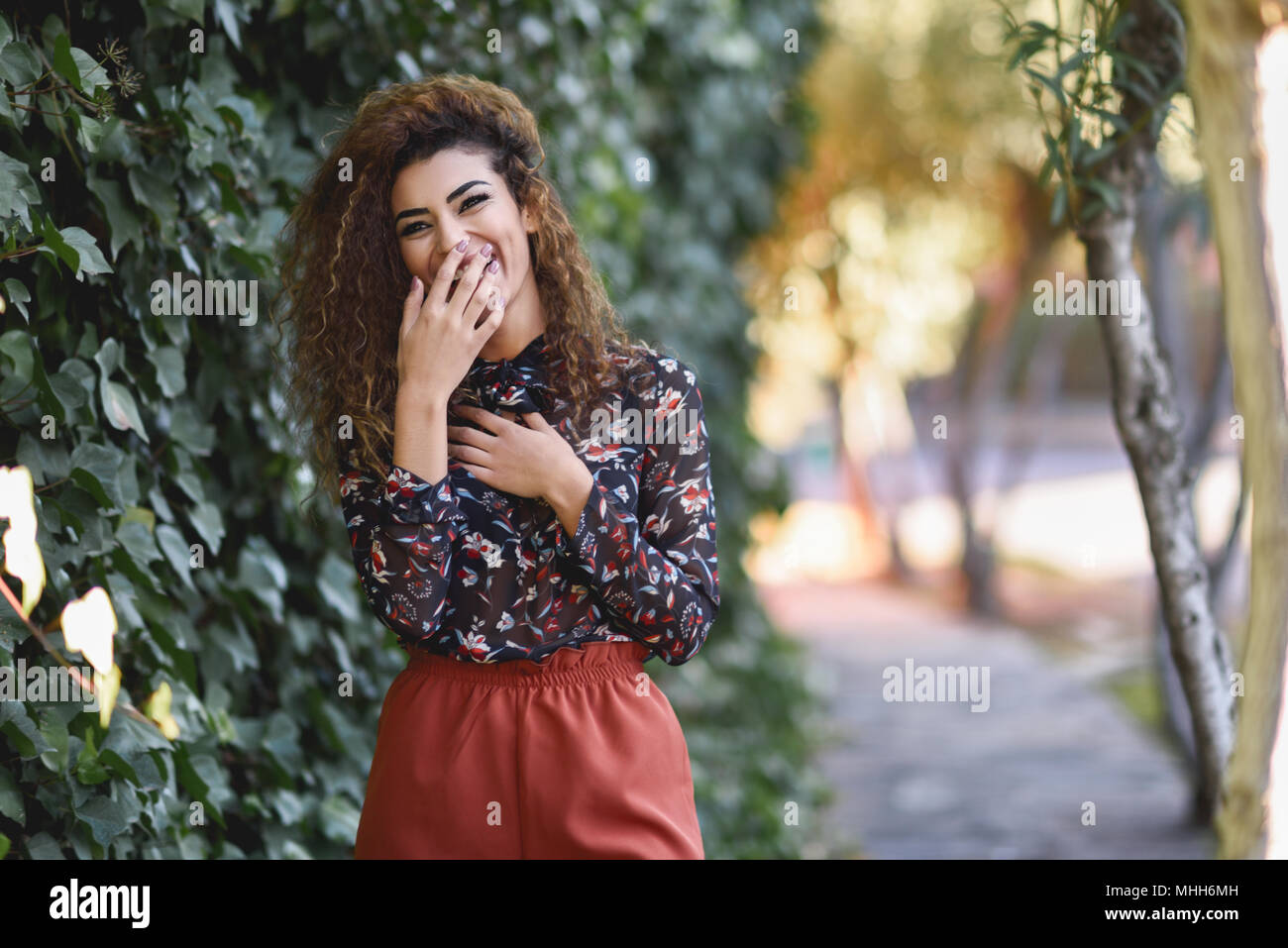 Beautiful young arabic woman laughing in urban background. Arab girl ...