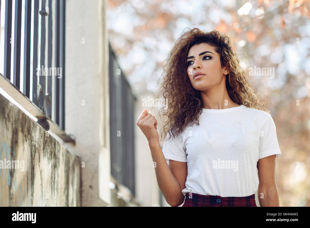 Beautiful young arabic woman with black curly hairstyle. Arab girl in ...