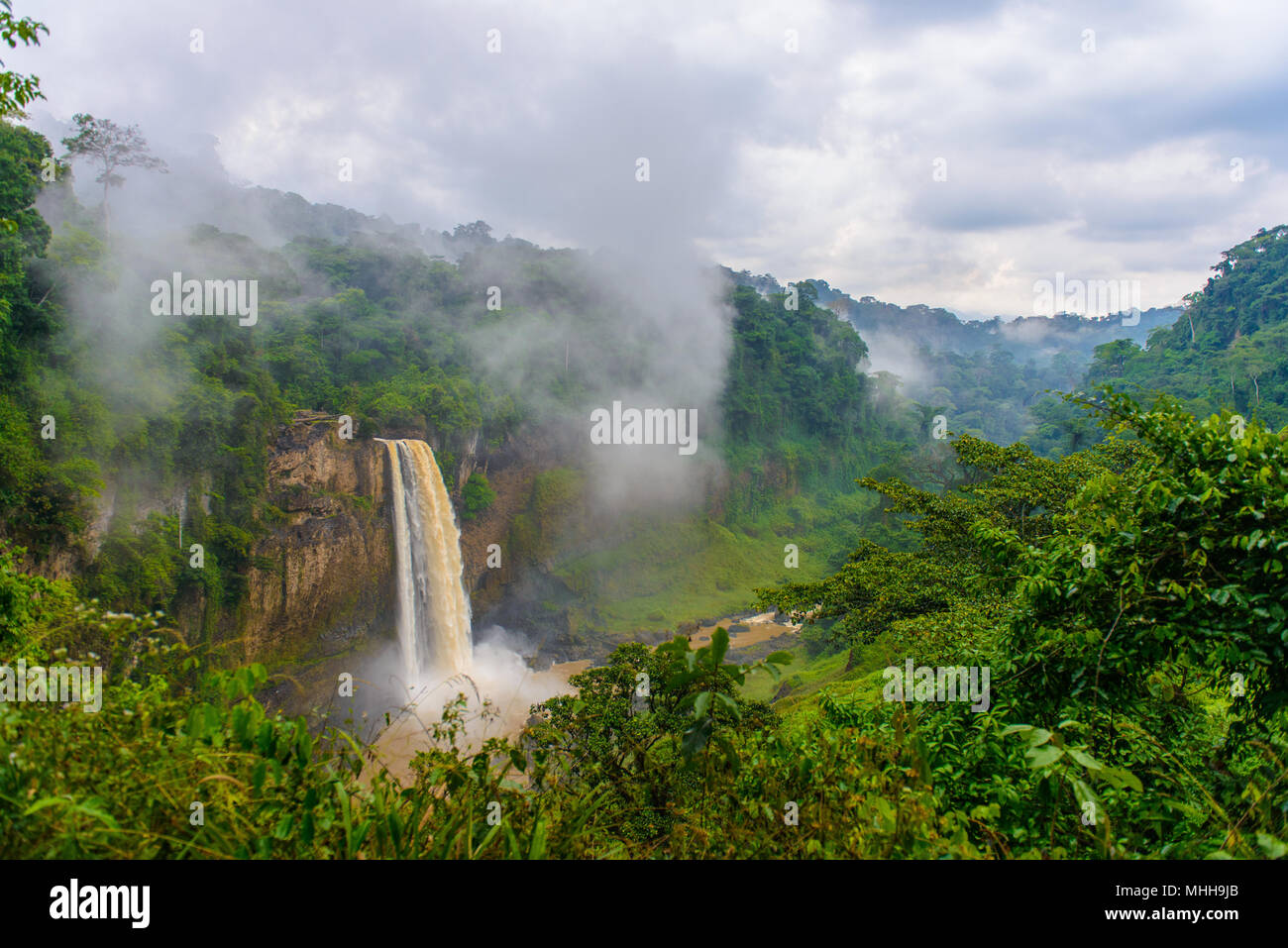 Water falls down out of the rock though the mist Stock Photo - Alamy