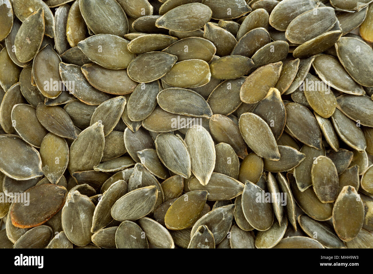 Macro background of green pumpkin seeds Stock Photo - Alamy