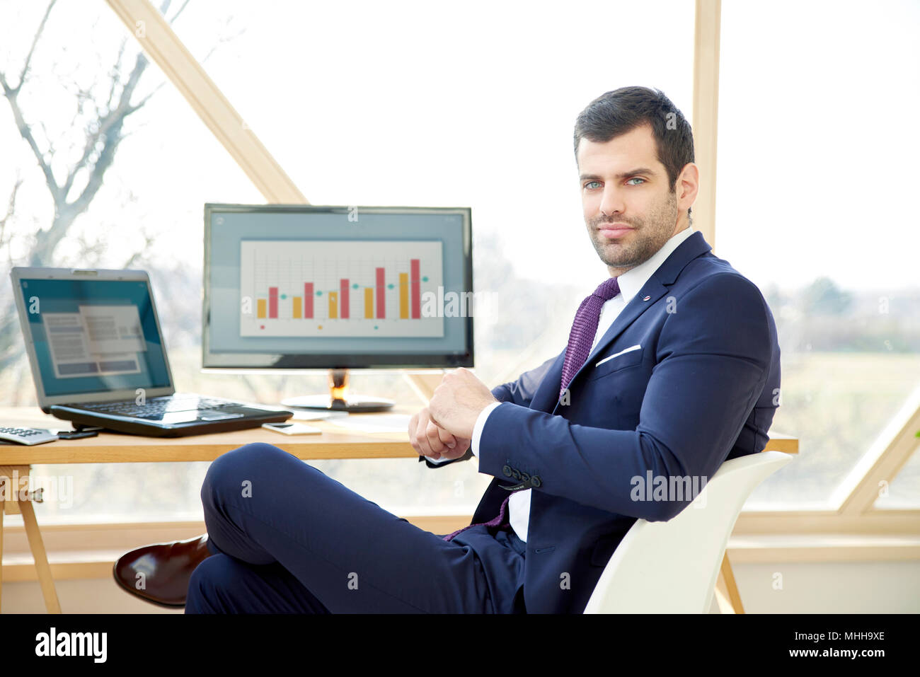 Portrait of young financial assistant businessman wearing suit while ...