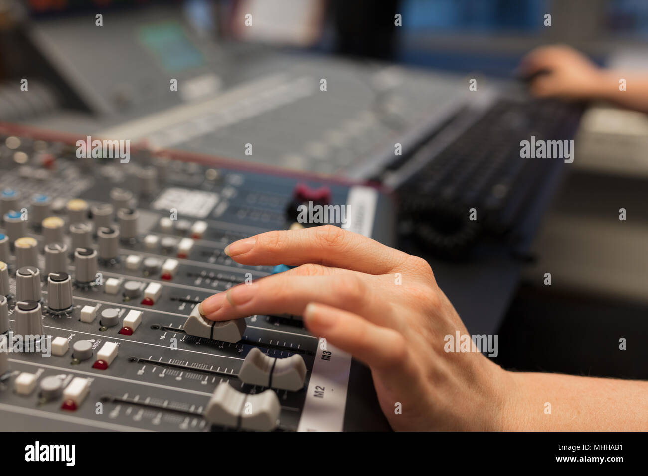 Female Radio Host Using Music Mixer In Studio Stock Photo - Alamy