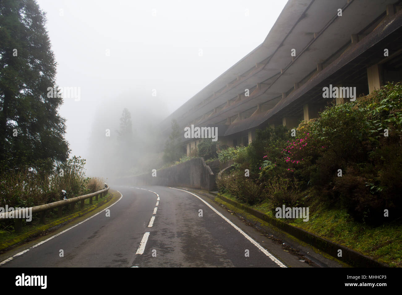 Abandoned hotel on mysterious road with fog Stock Photo - Alamy