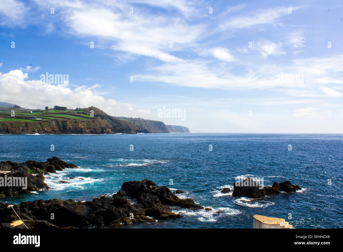 Coastline landscape with Blue Ocean and land with green fields Stock ...