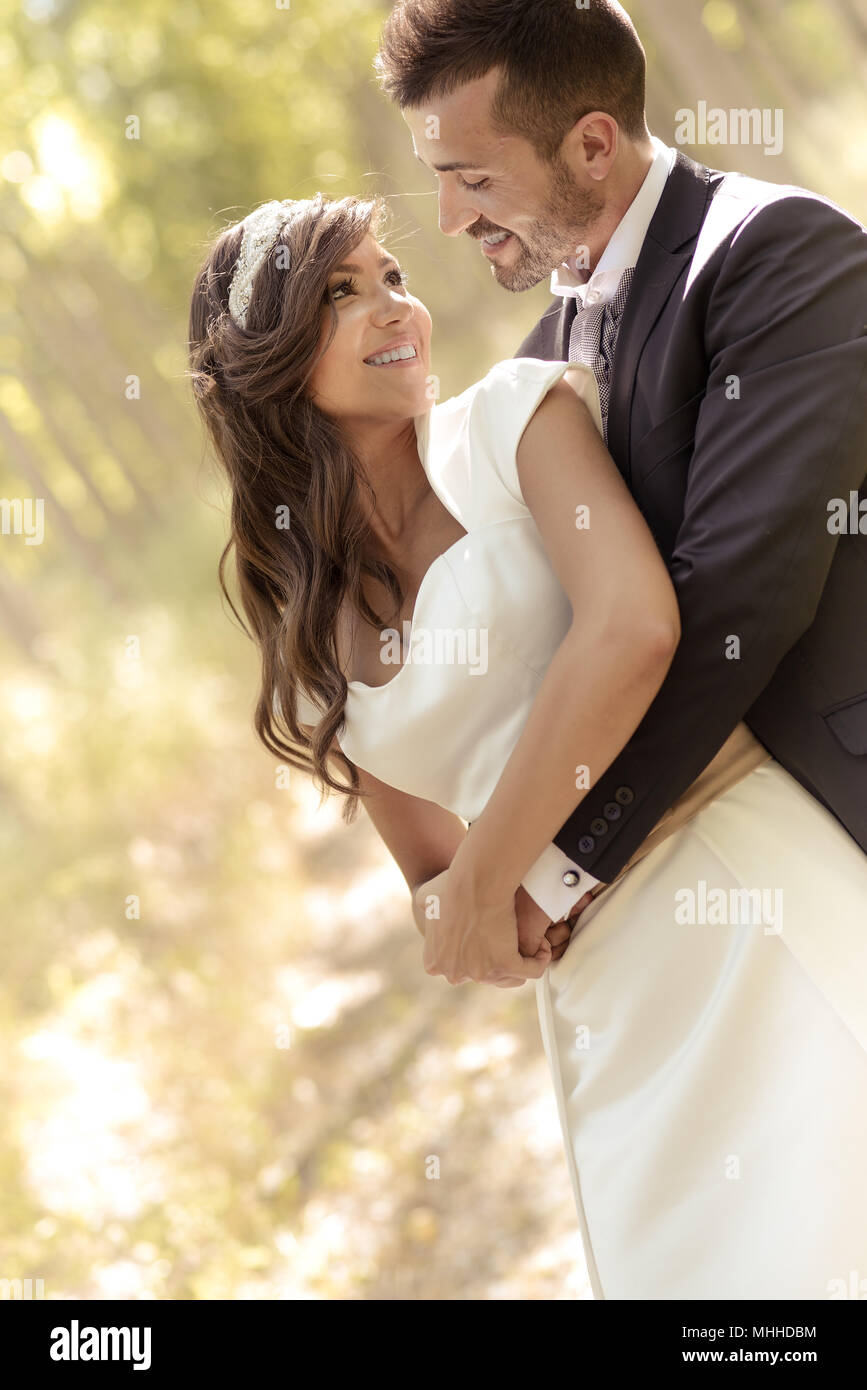 Just married couple together in poplar background Stock Photo - Alamy