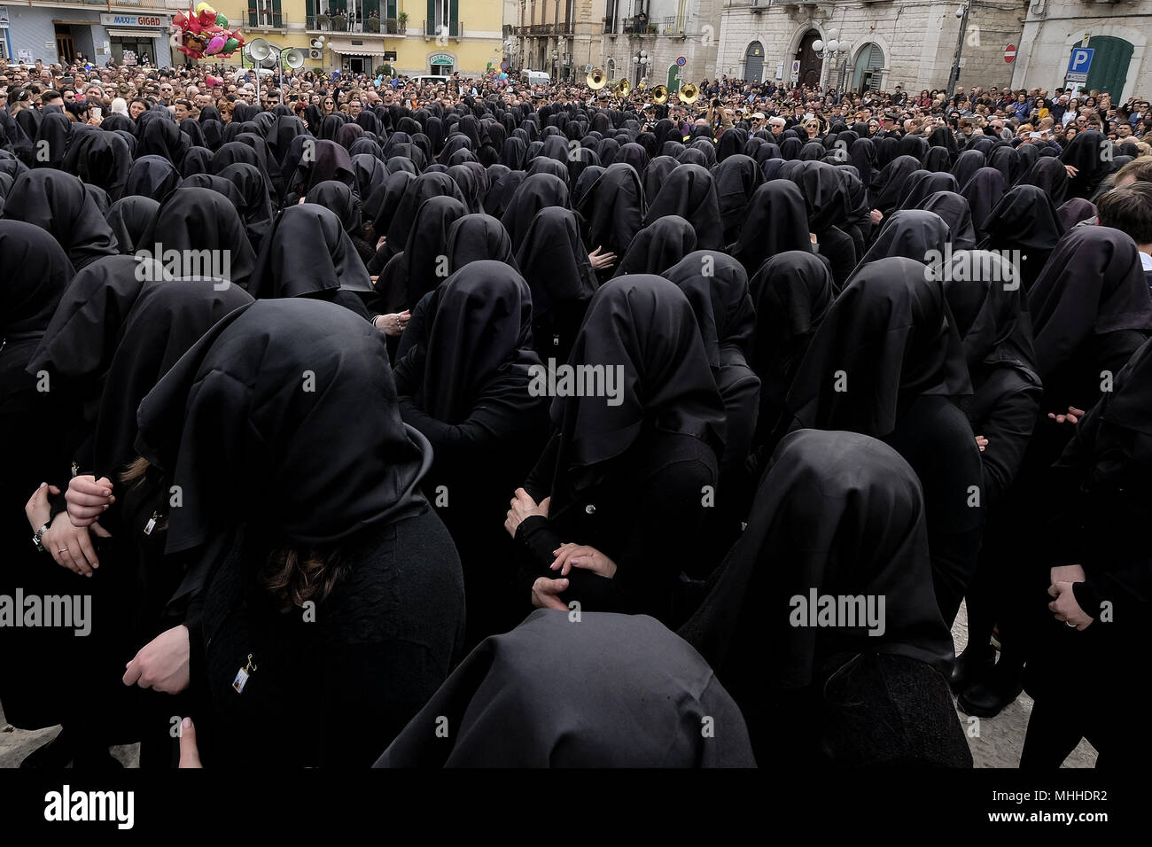 Penitent women dressed in black walk and sing religious songs during ...