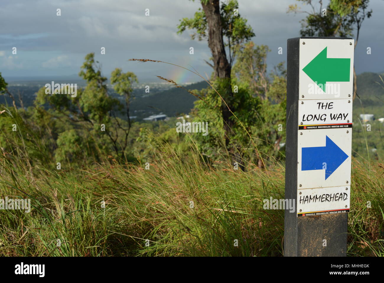 Rainbow over a city as scene from a wooded mountain, Mount Stuart ...