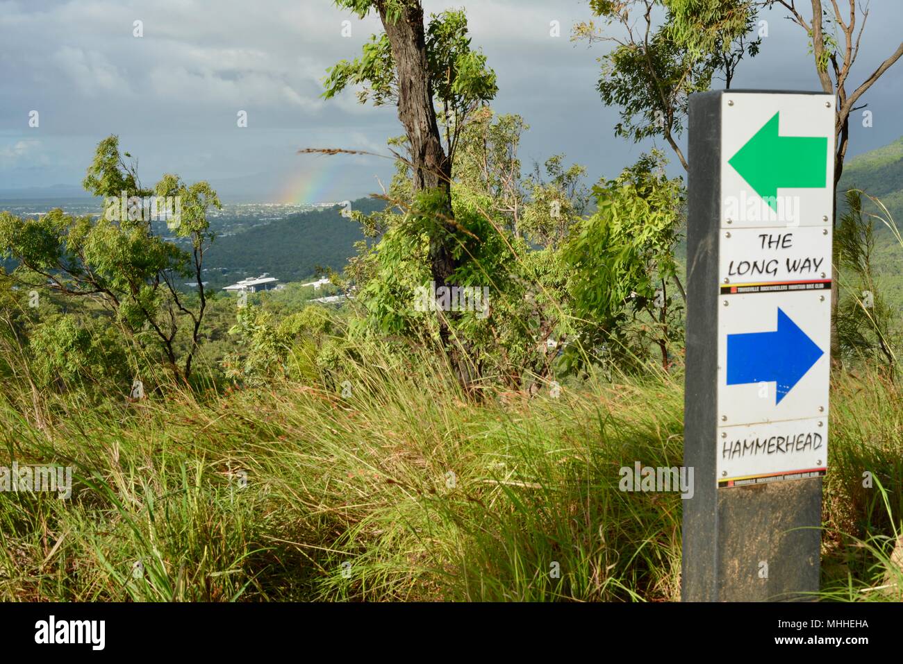 Rainbow over a city as scene from a wooded mountain, Mount Stuart ...