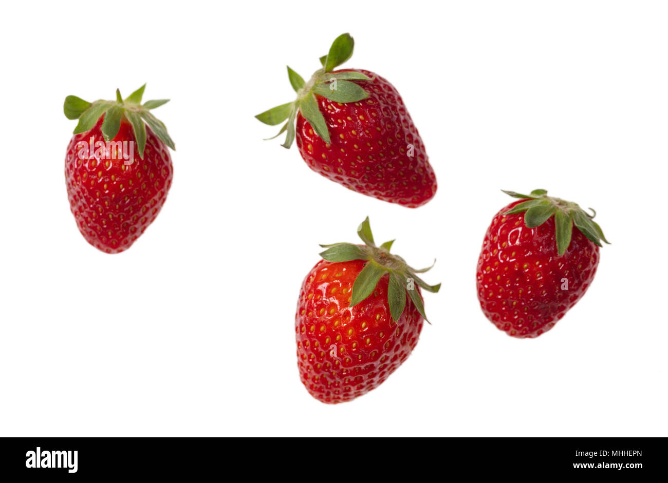 Four fresh strawberries isolated on white background Stock Photo - Alamy