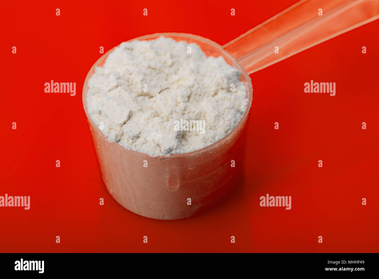 Creatine monohydrate in scoop on creatine monohydrate background with ...