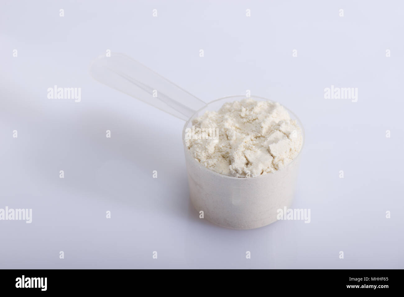 Creatine monohydrate in scoop on creatine monohydrate background with ...