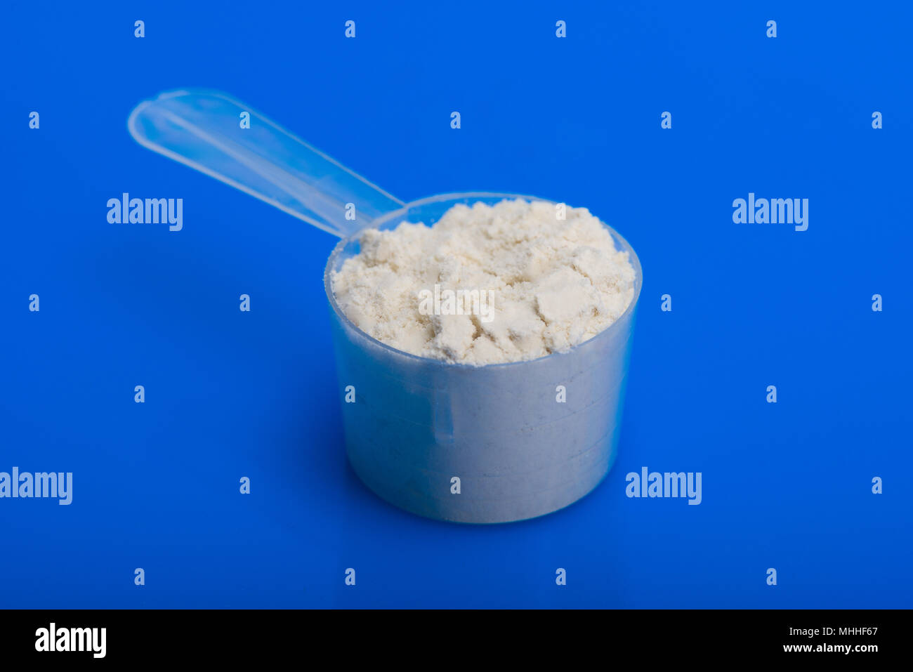 Creatine monohydrate in scoop on creatine monohydrate background with ...