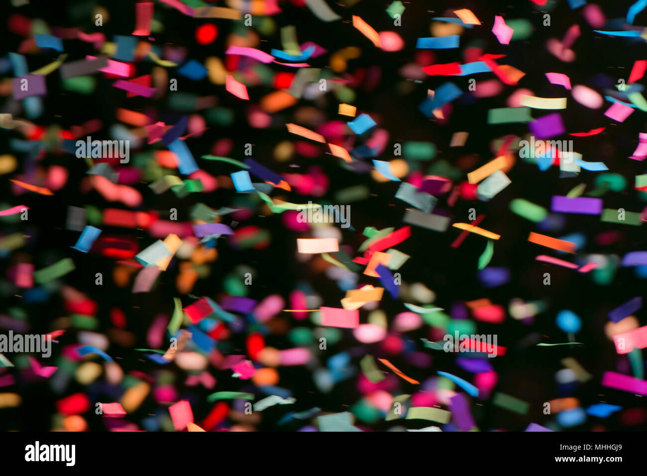 Colorful streamers on black background Stock Photo - Alamy