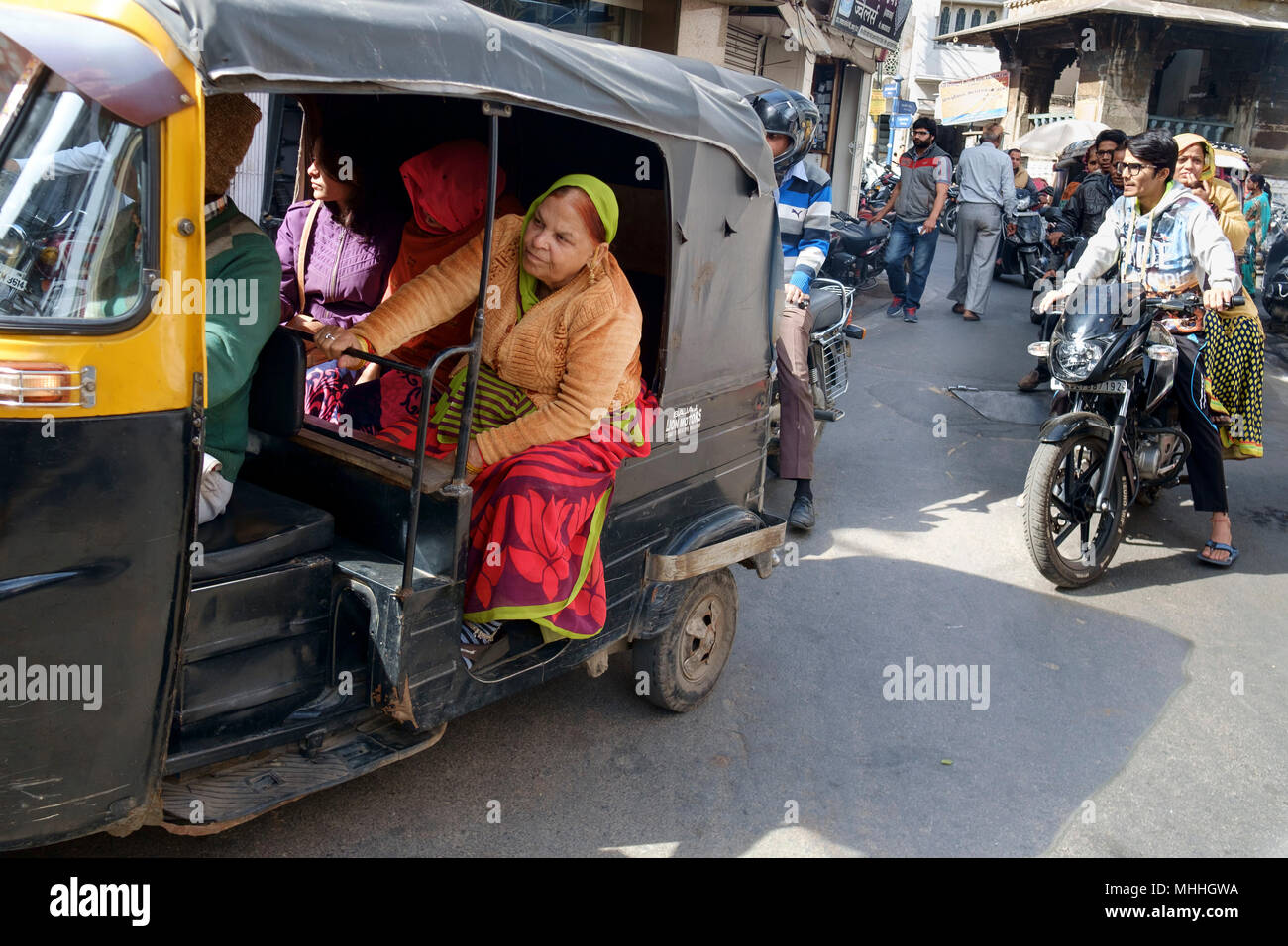 Women in a tuk tuk moving through the crowded streets. Udaipur, also ...