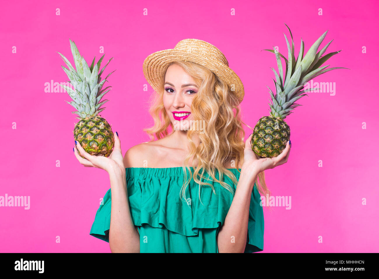 Portrait of happy woman and pineapple over pink background. Summer ...