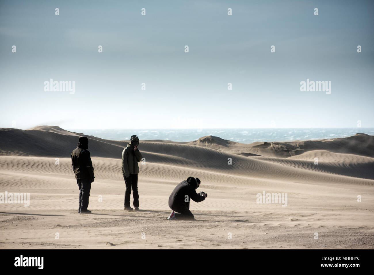 people walking on ocean beach sand dunes Stock Photo - Alamy