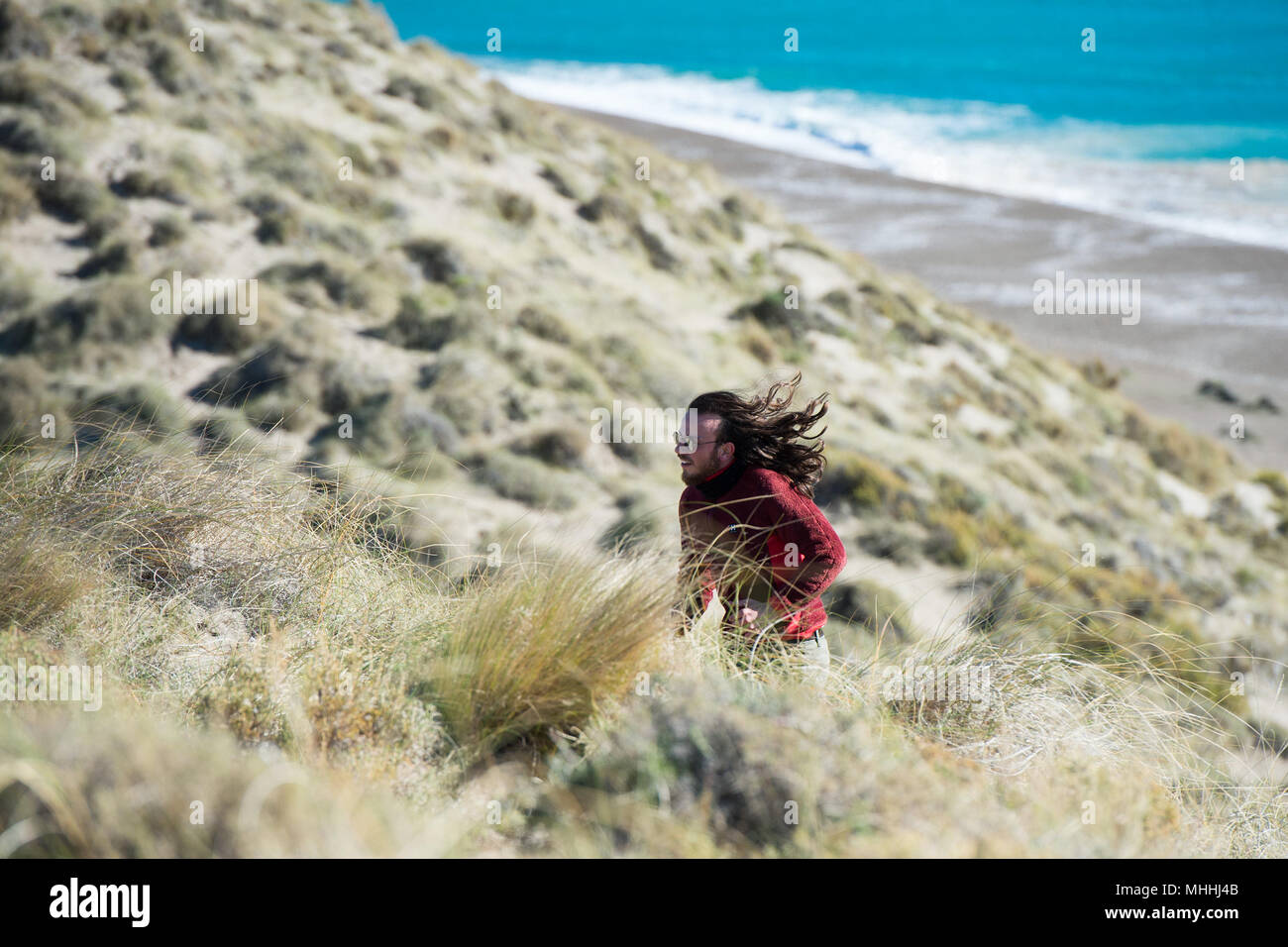 Long hair male running hi-res stock photography and images - Alamy
