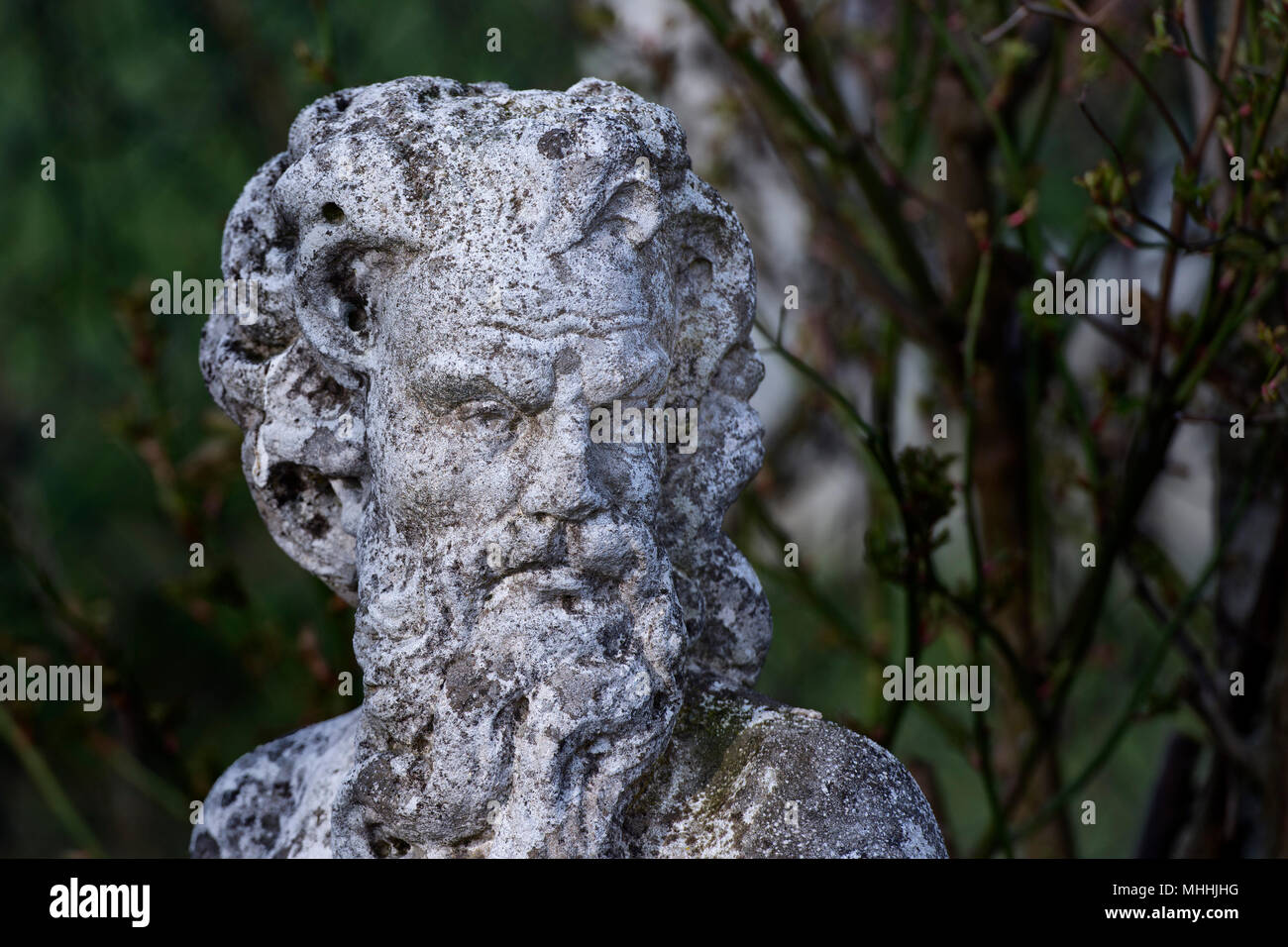 Old faun sculpture on forest background Stock Photo - Alamy