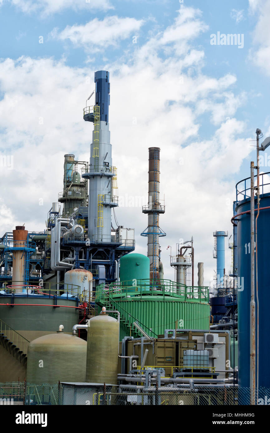 oil refinery on blue sky cloudy background Stock Photo - Alamy