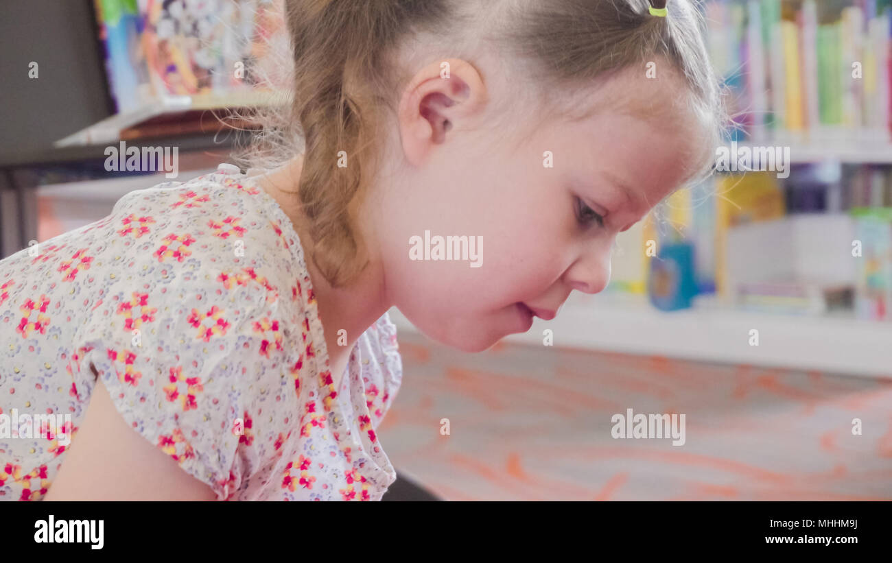 Little girl playing in kids section of public library Stock Photo - Alamy
