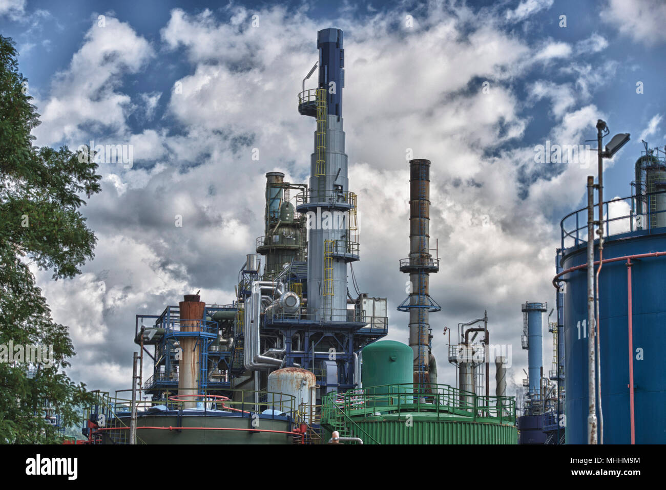 oil refinery on blue sky cloudy background Stock Photo - Alamy