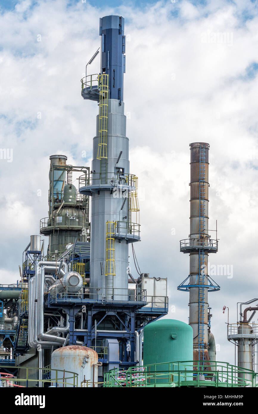 oil refinery on blue sky cloudy background Stock Photo - Alamy