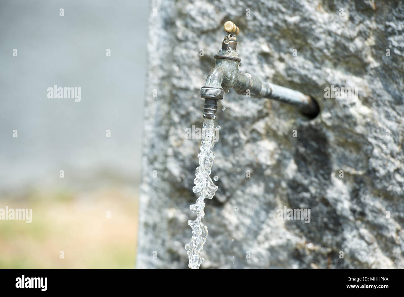 water falling from open tap in countryside Stock Photo - Alamy