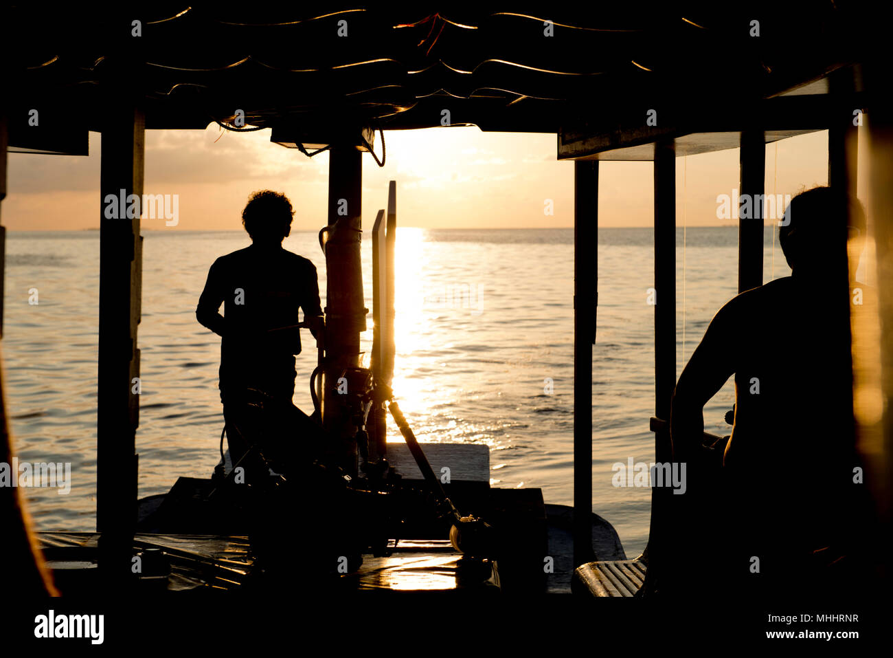 boat captain silhouette on sunset background Stock Photo - Alamy