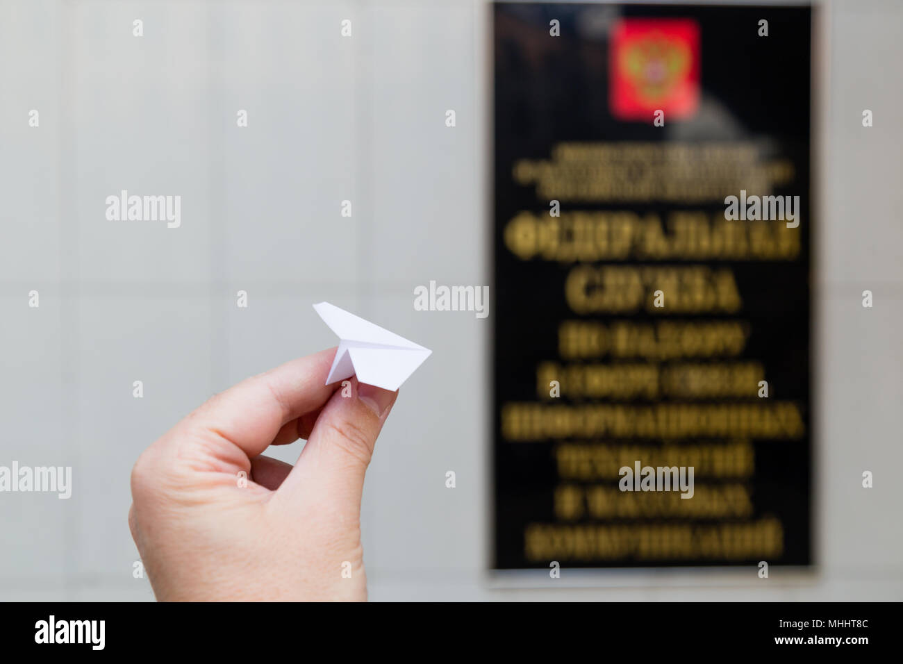 MOSCOW, RUSSIA - APRIL 30, 2018: A paper plane in hand on the ...