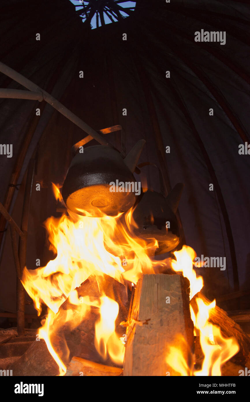 cooking on the campfire inside a tent in winter time Stock Photo - Alamy